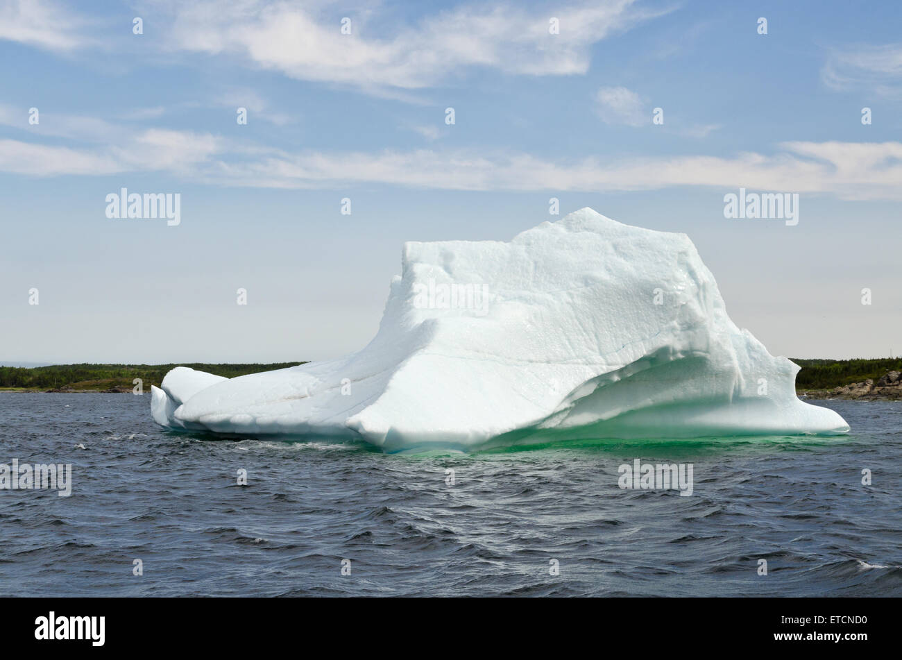 Bright white iceberg on dark water and rock background Stock Photo - Alamy