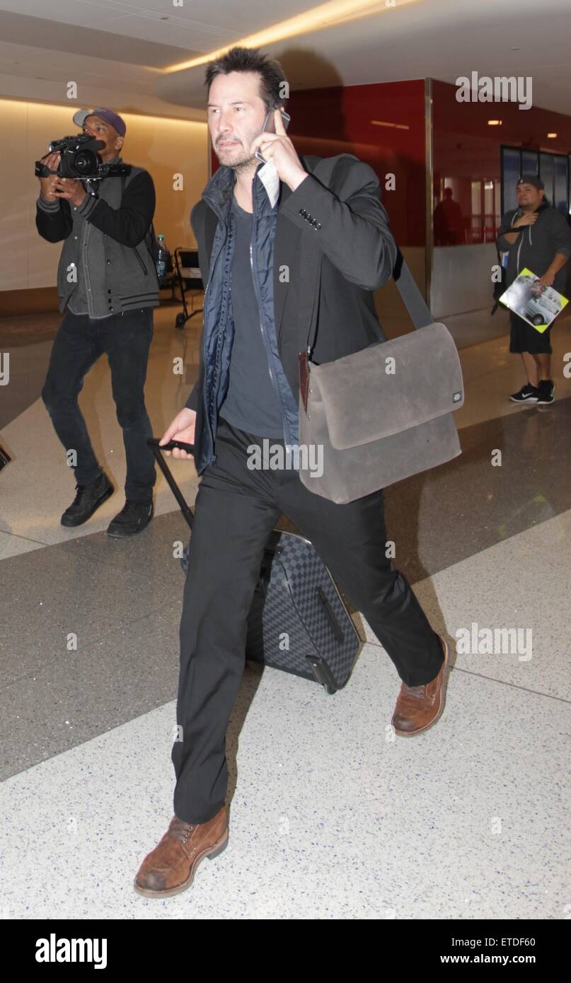 Keanu Reeves chats on his mobile phone as he departs from LAX airpot in ...