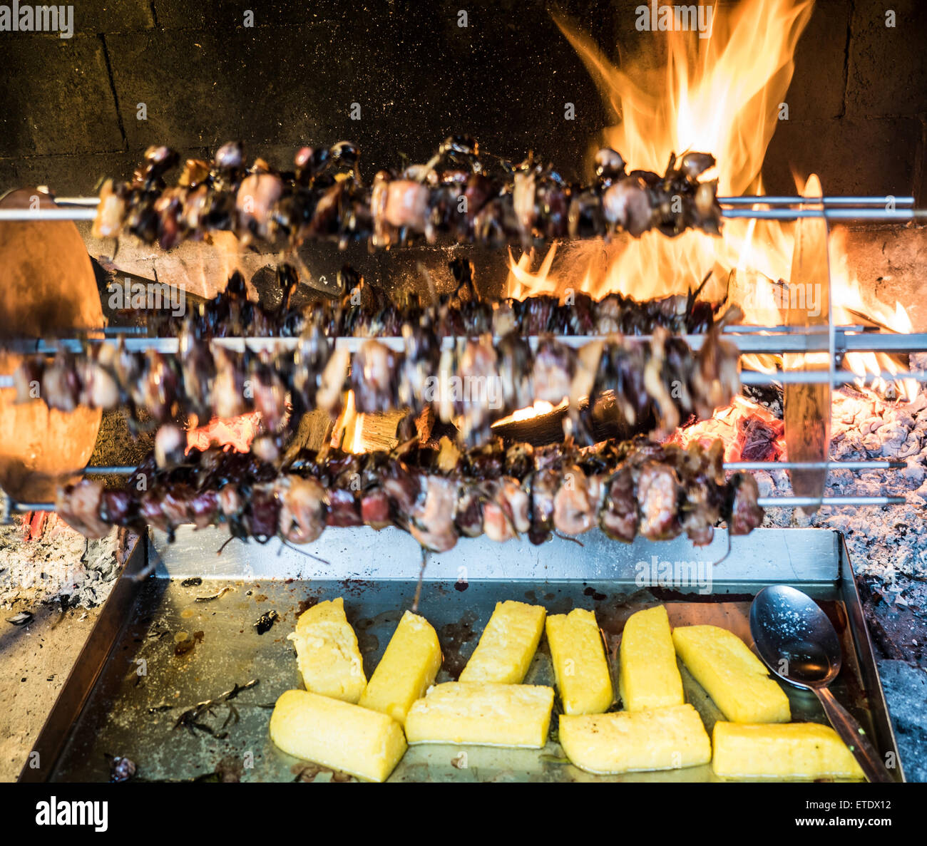 birds turning on a spit and cook slowly to the heat of the flame in the ...