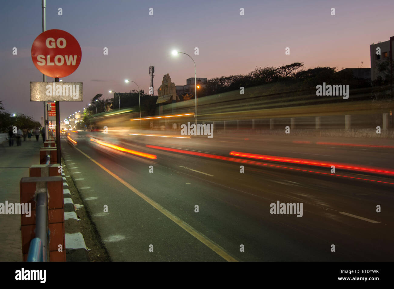 Traffic speeds past a go slow sign in Chennai India Stock Photo - Alamy
