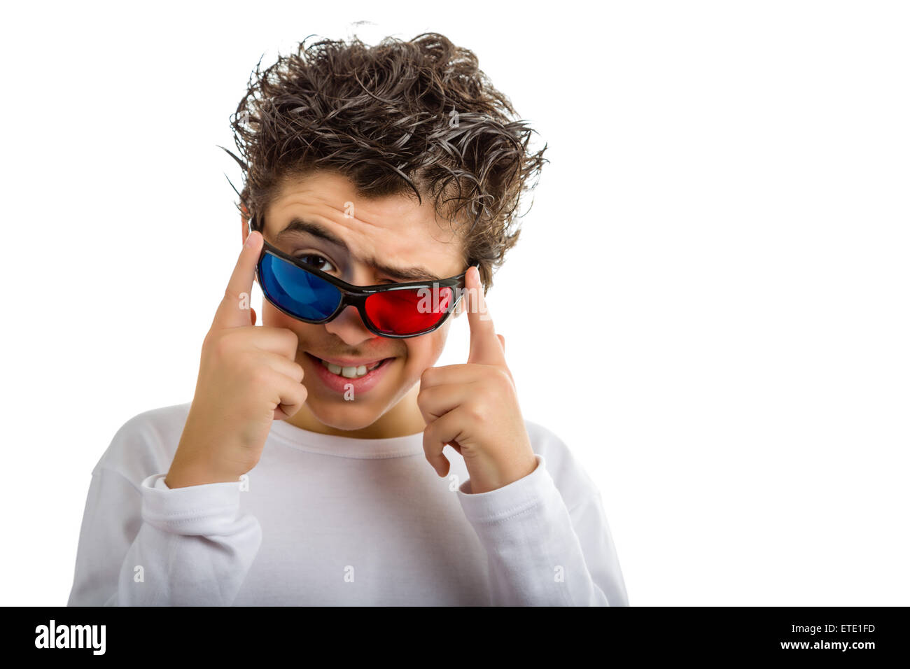 A cute Hispanic boy wears a pair of 3D Cinema eyeglasses with red and ...