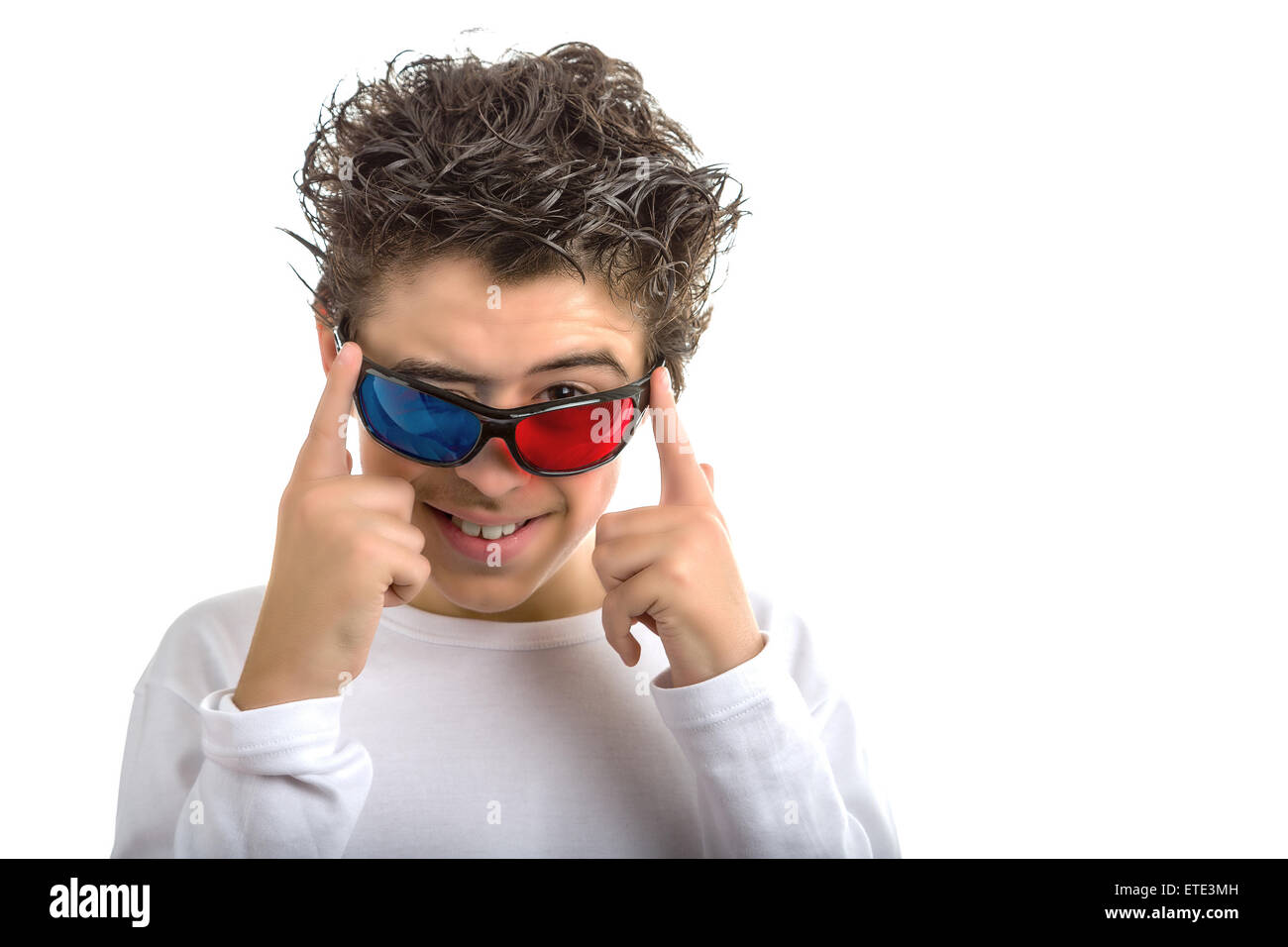 A cute Hispanic boy wears a pair of 3D Cinema eyeglasses with red and ...