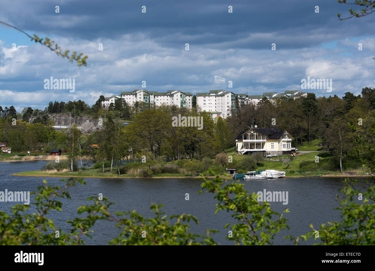 High rise buildings contrasting with old small residential wooden home ...