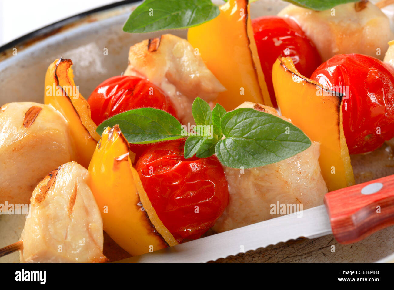 Grilled chicken chunks with cherry tomatoes and yellow pepper on ...