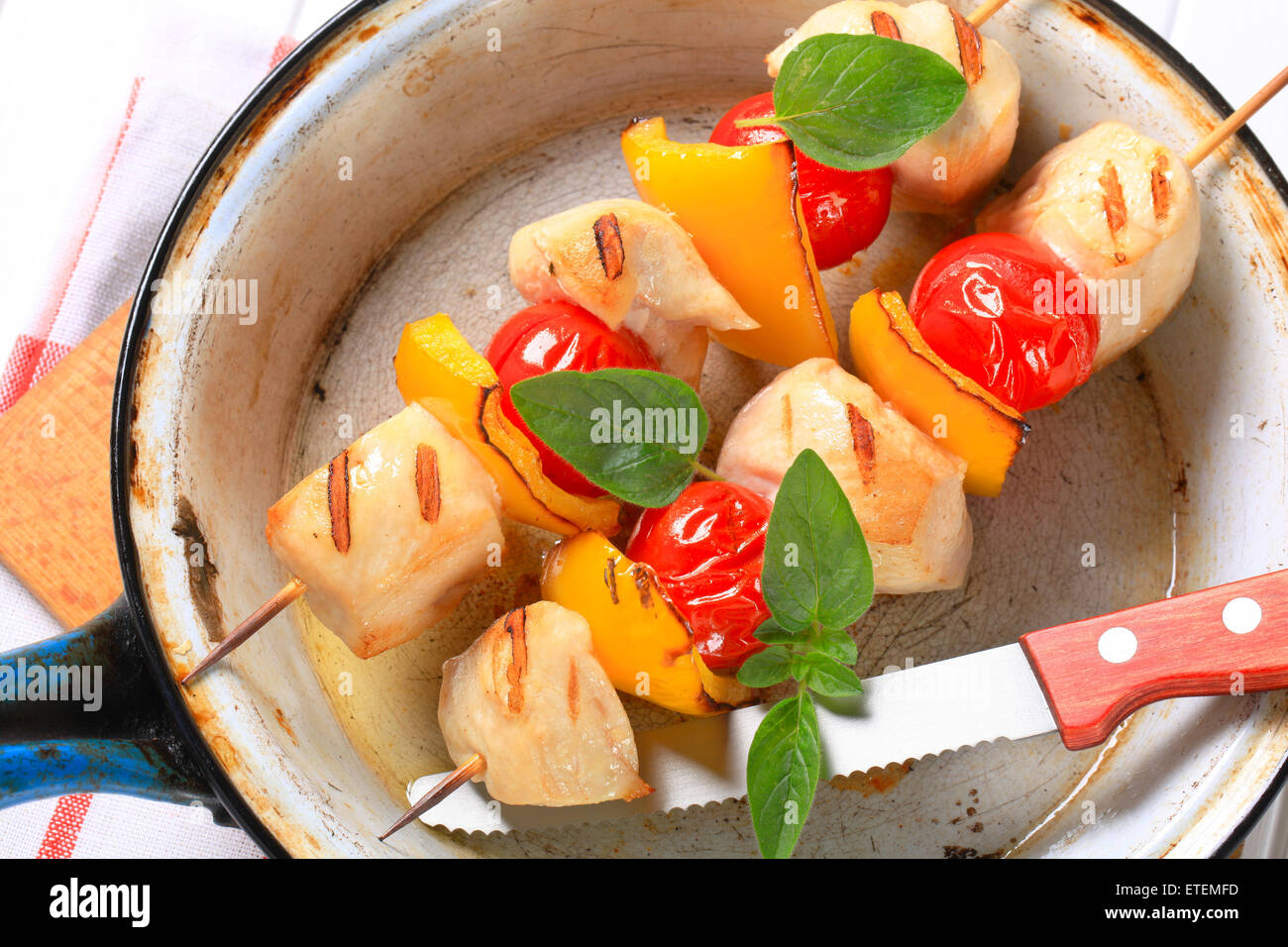 Grilled chicken chunks with cherry tomatoes and yellow pepper on ...
