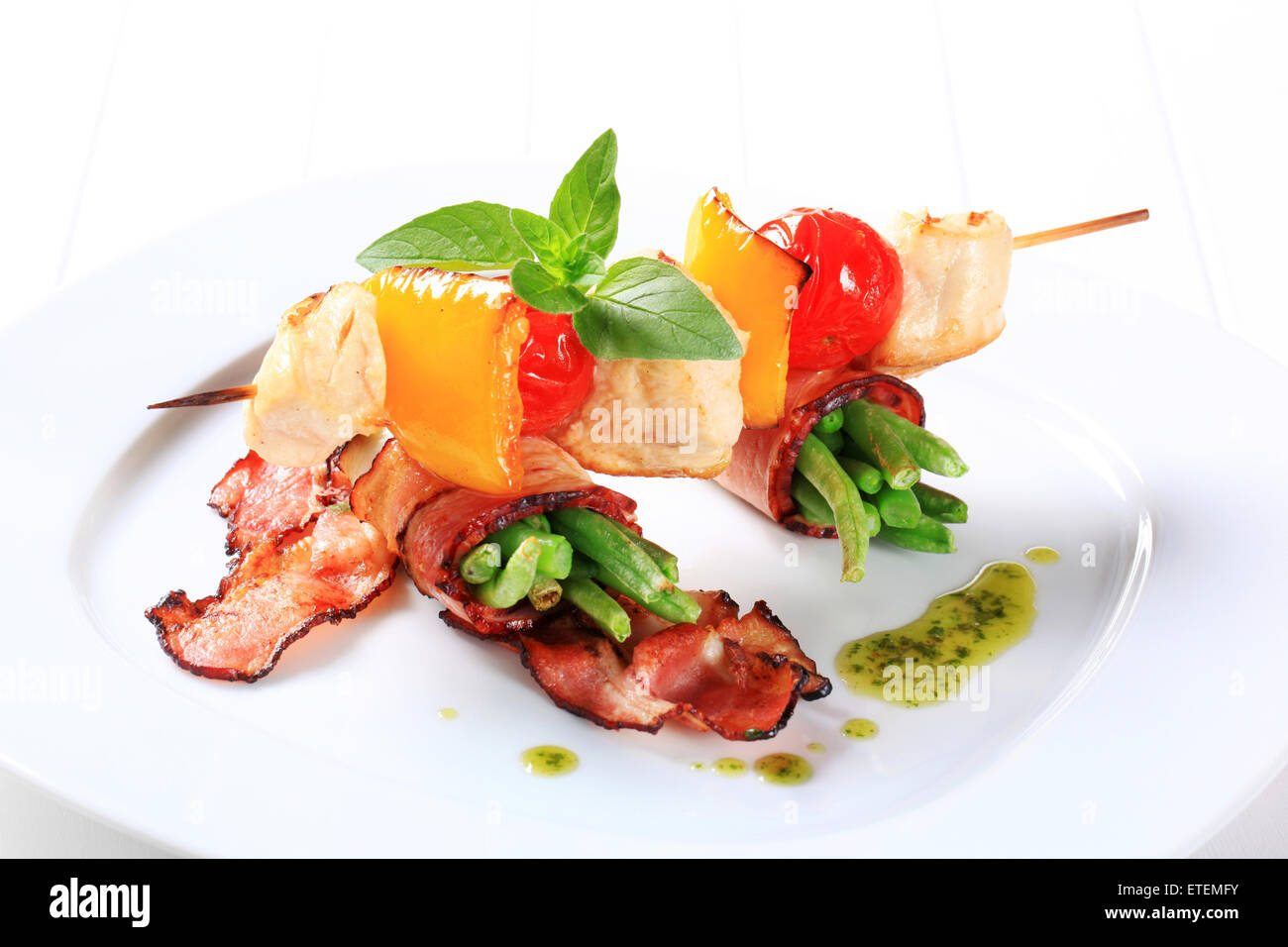 Chicken skewer and string beans wrapped in bacon Stock Photo - Alamy