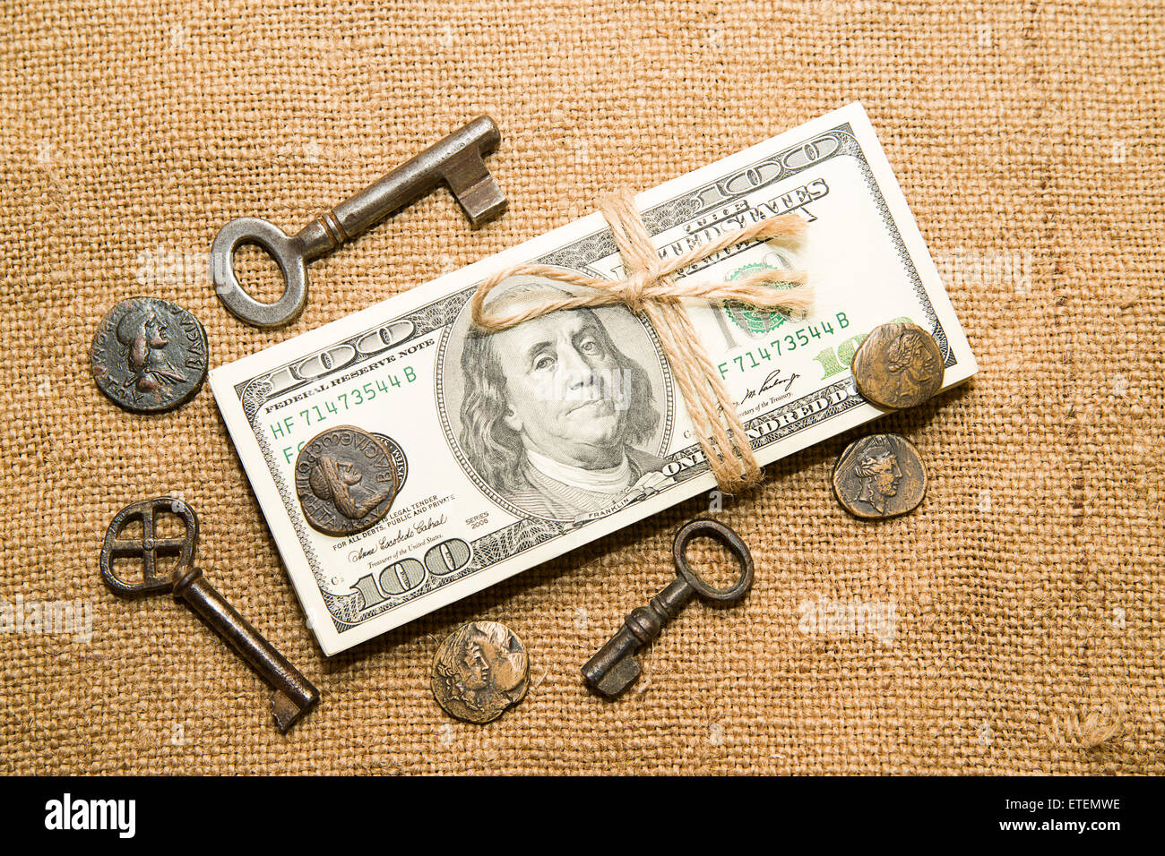 One pack of dollars tied up with rope, coins and keys in the old cloth ...