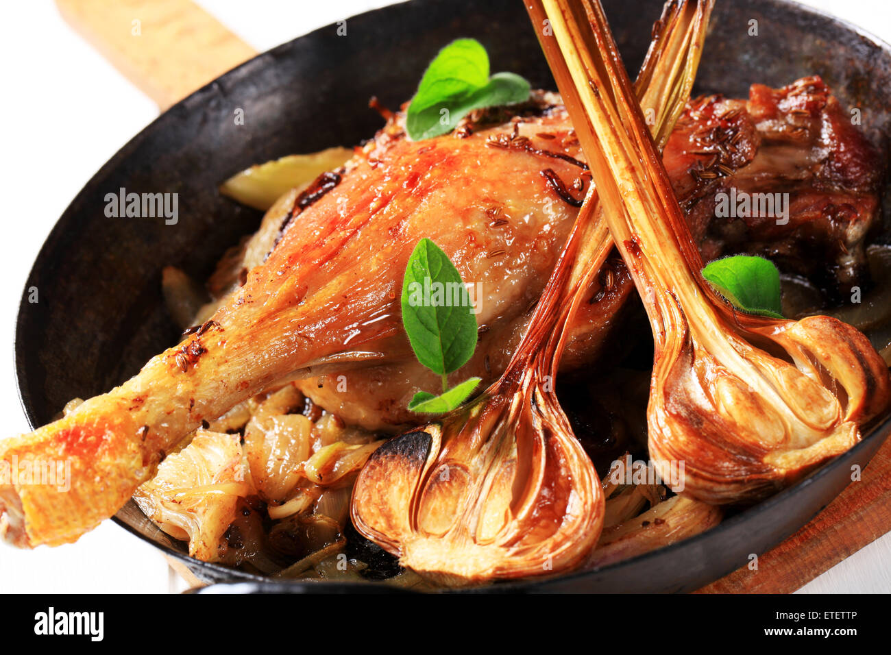 Roast duck leg with sauteed onion Stock Photo - Alamy