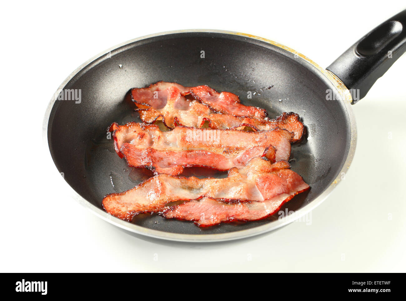 Strips of fried bacon on frying pan Stock Photo - Alamy
