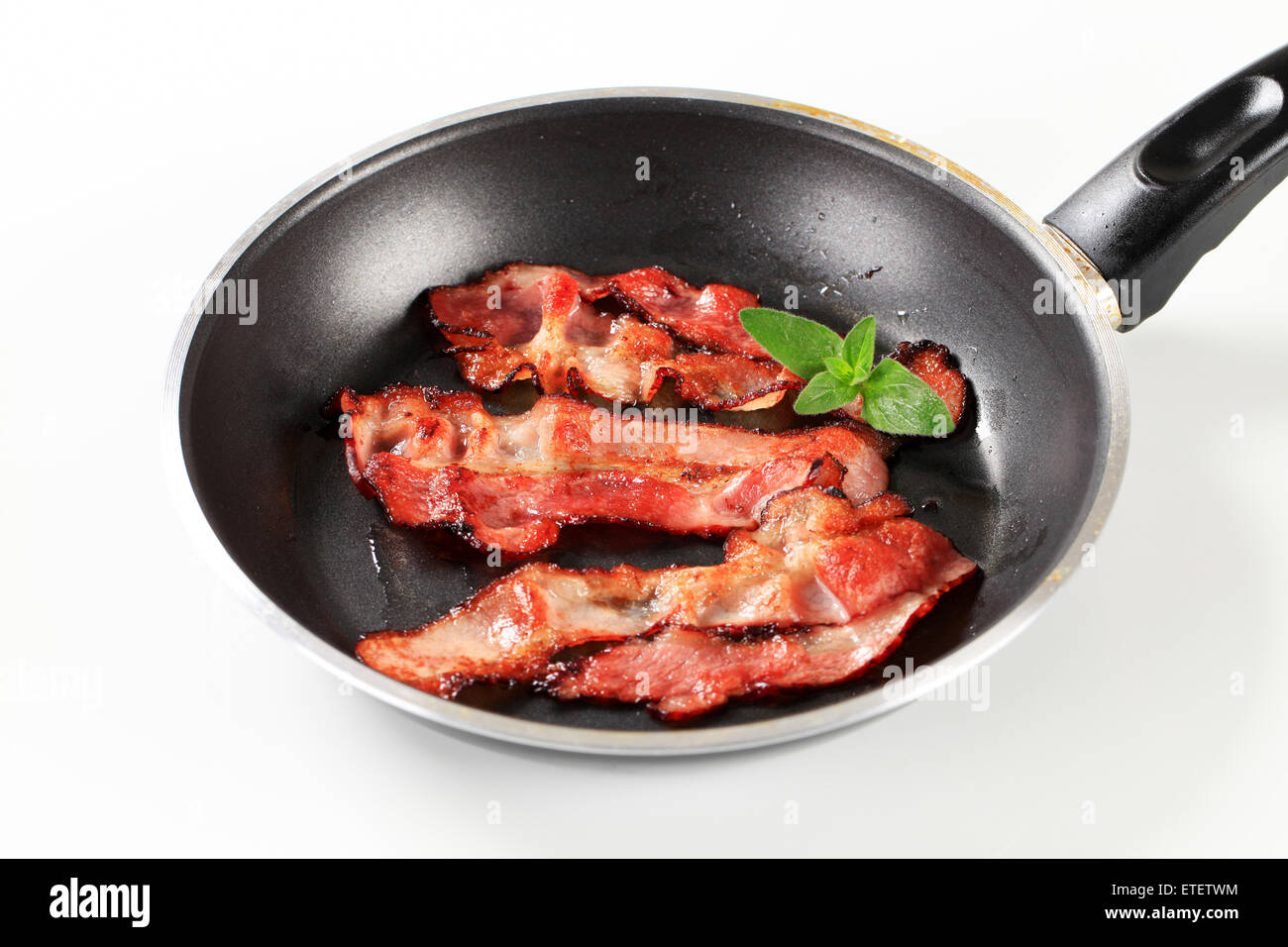 Strips of fried bacon on frying pan Stock Photo - Alamy