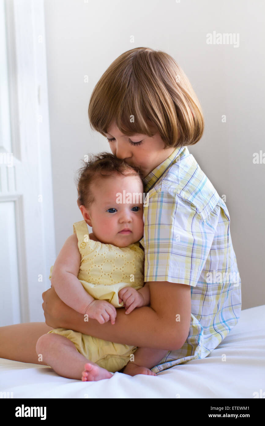 Cute brother and baby sister, siblings, playing together Stock Photo ...