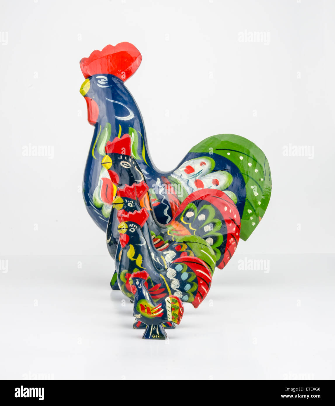A row of five painted antique wooden chickens in increasing sizes Stock ...