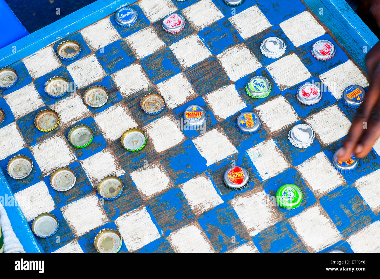 Playing draughs with makeshift board and tokens, Nyamirambo, Kigali ...