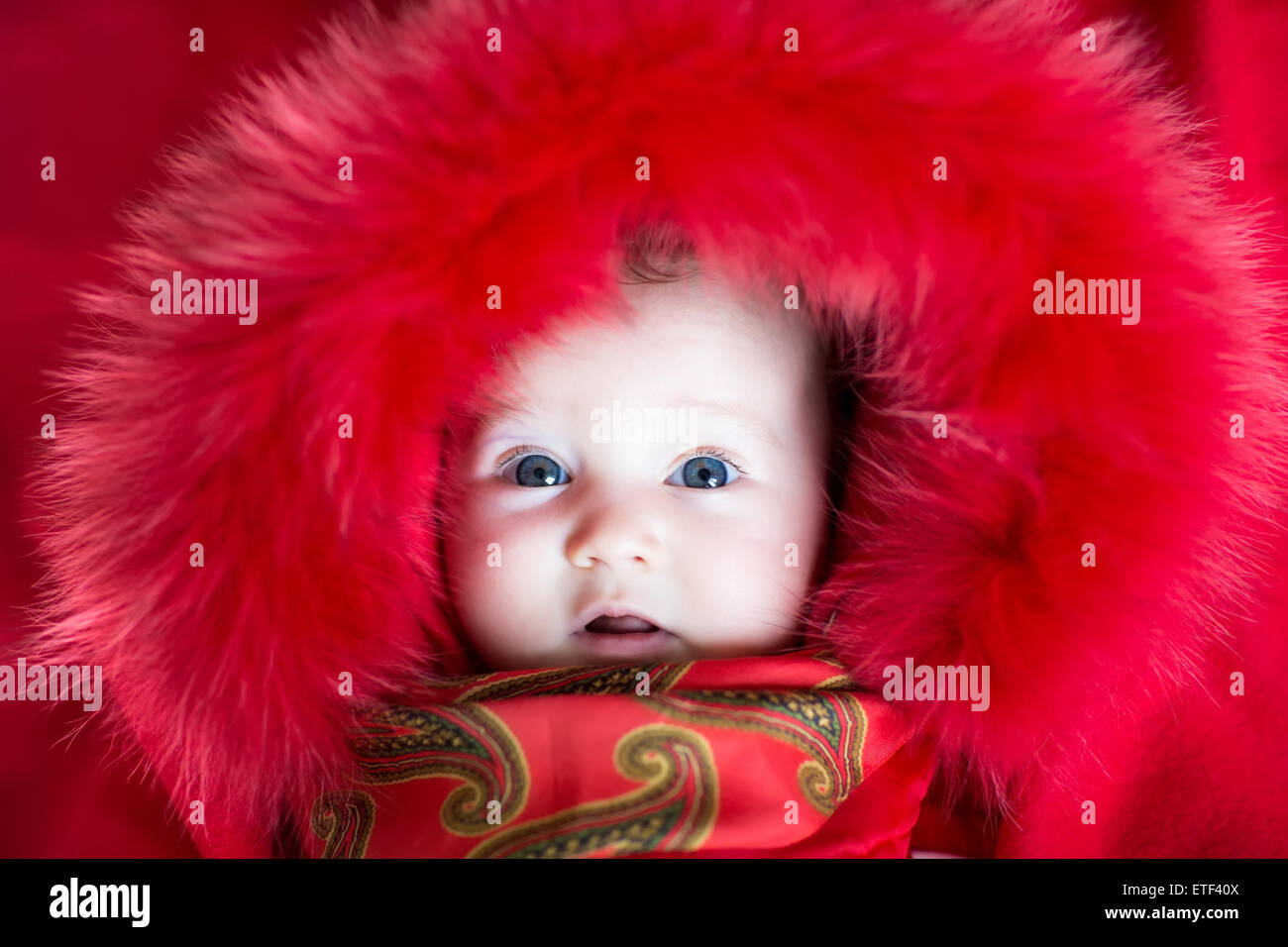Little baby girl in a red fur jacket Stock Photo - Alamy