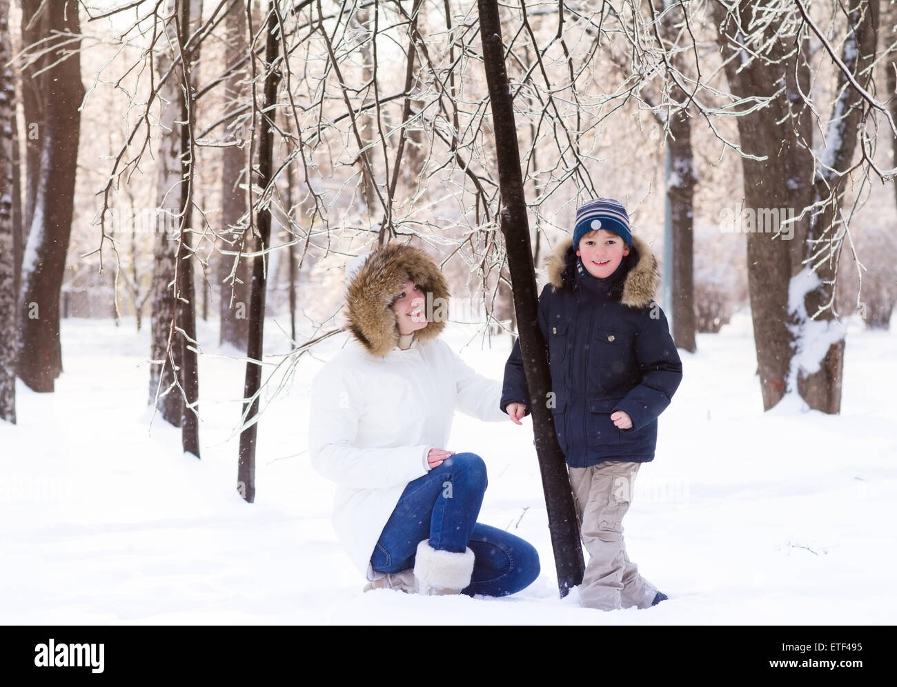 Mother and child playing in deep snow on sunset Stock Photo - Alamy