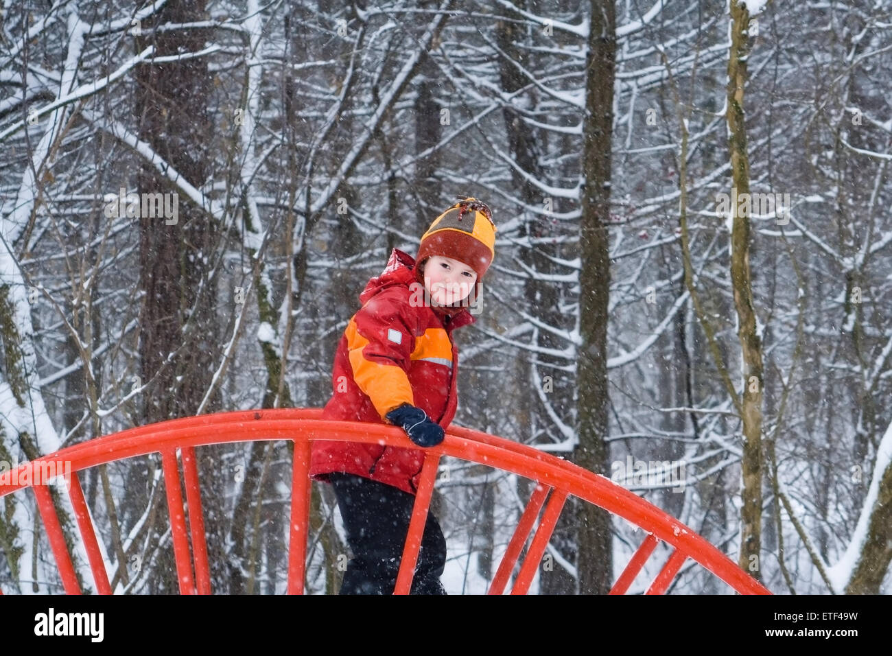Little child on a playground on a snowy day Stock Photo - Alamy