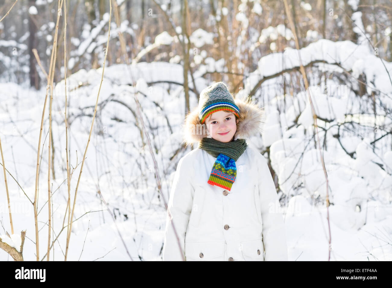 Happy child playing in a snow field on a sunny winter day Stock Photo ...