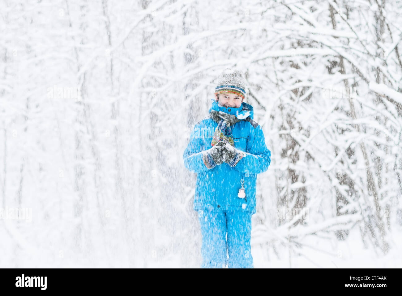Funny boy caught in a snow storm Stock Photo - Alamy