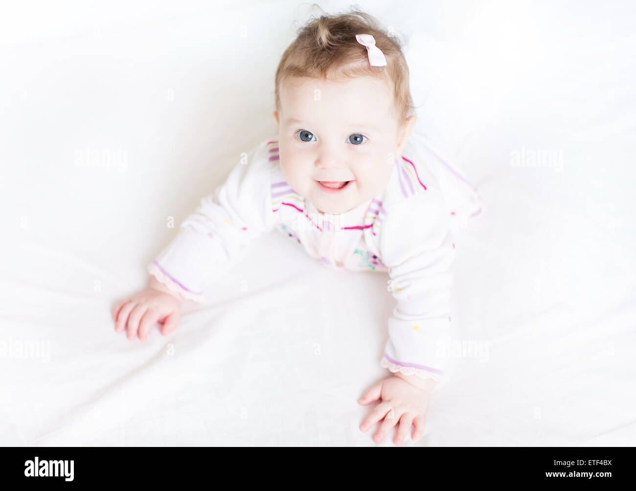 Beautiful baby girl playing on her tummy Stock Photo - Alamy