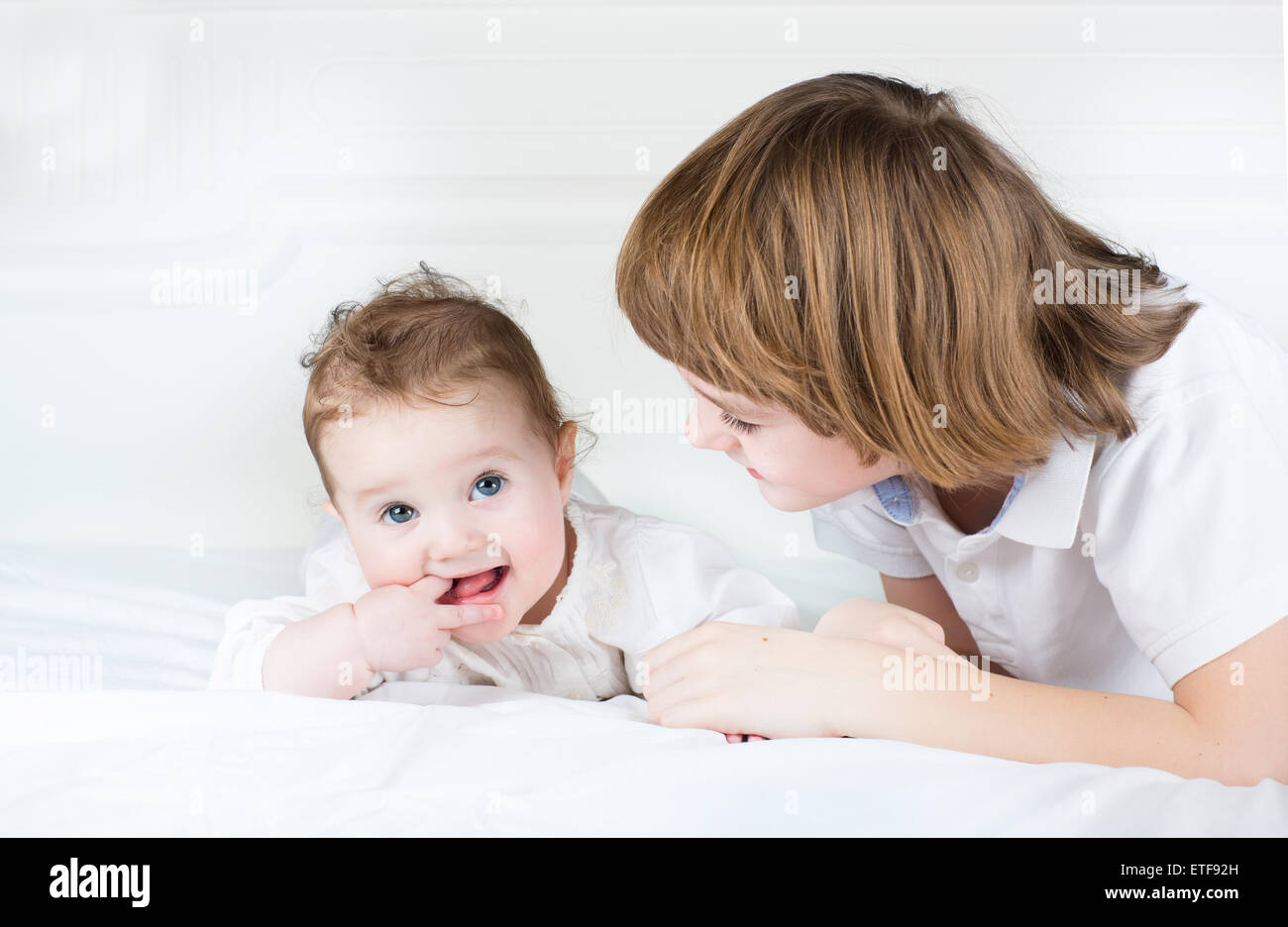 Cute brother and baby sister, siblings, playing together Stock Photo ...