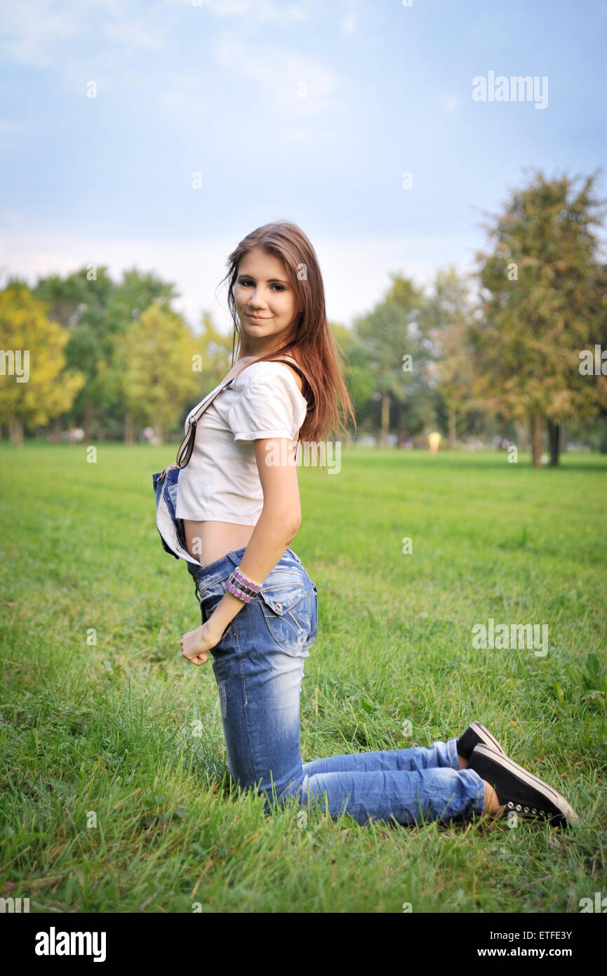 student with long hair in jeans on a meadow Stock Photo - Alamy