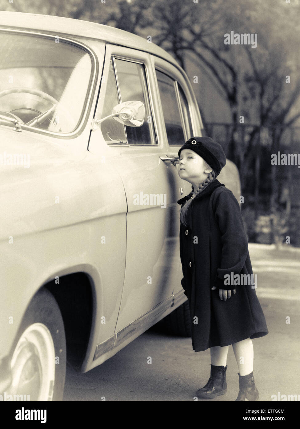 Cute little girl dressed in retro coat posing near oldtimer car, sixties Stock Photo - Alamy