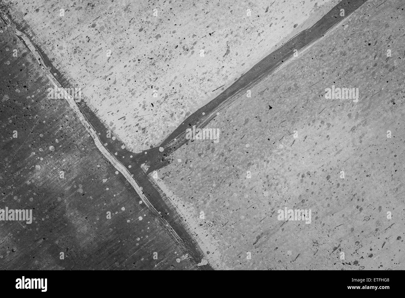 Diagonal cement lines of angled cement form an exterior retaining wall ...