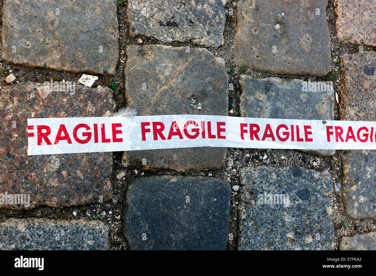 A fragile line on the pavement tape Stock Photo - Alamy