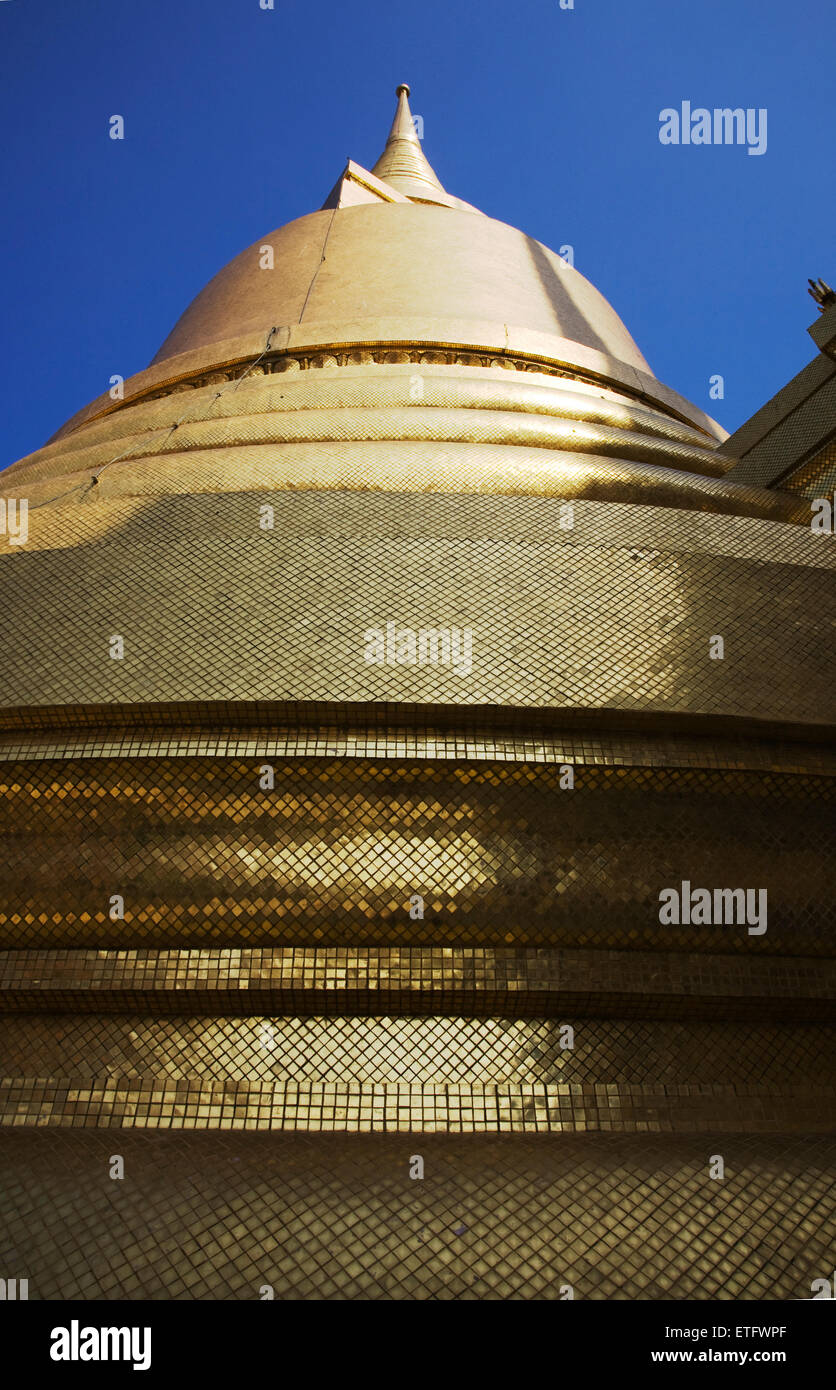 A large golden stupa or chedi at the Grand Palace is covered in gold ...
