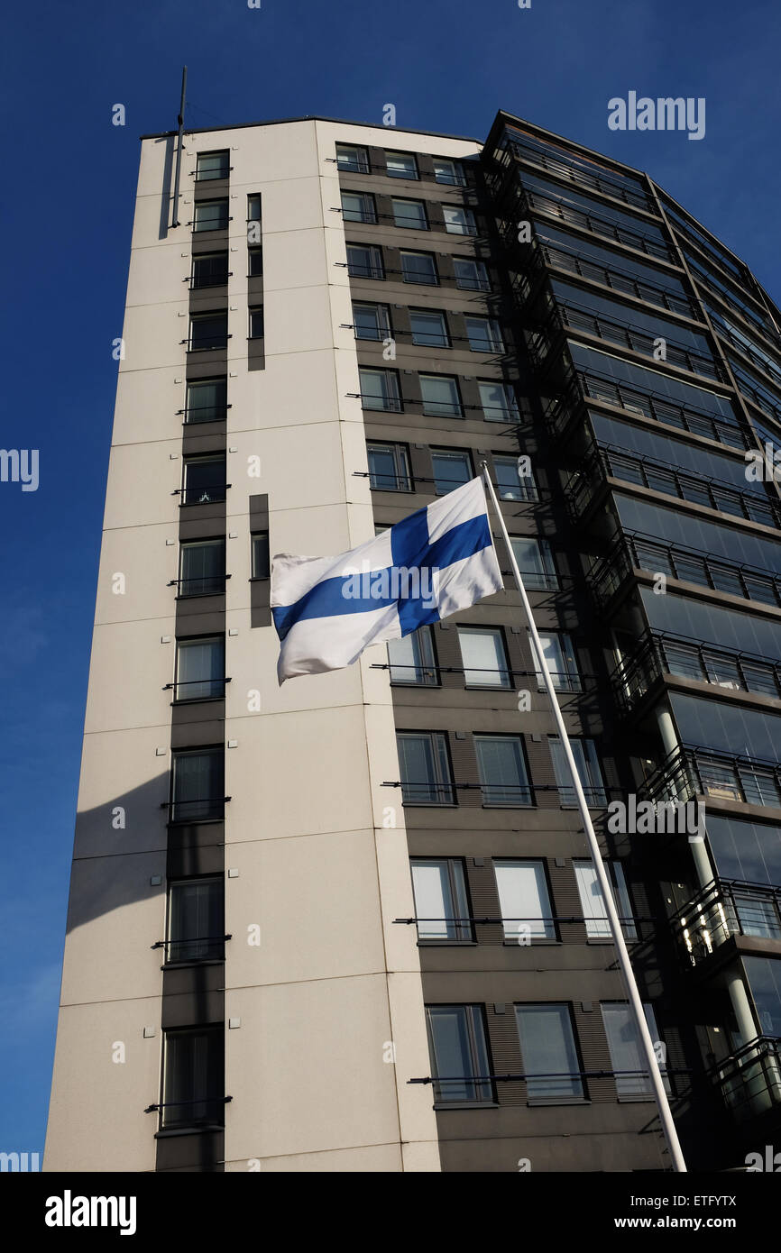 fluttering national flag of Finland beside modern building, vertical ...