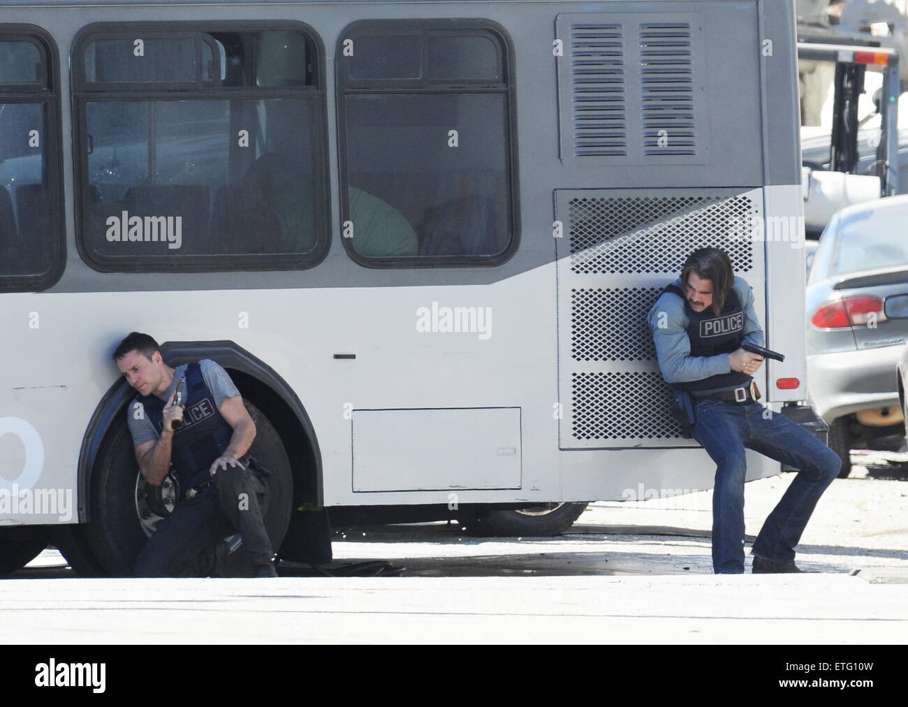 Actor Colin Farrell draws his gun in an action scene for 'True ...