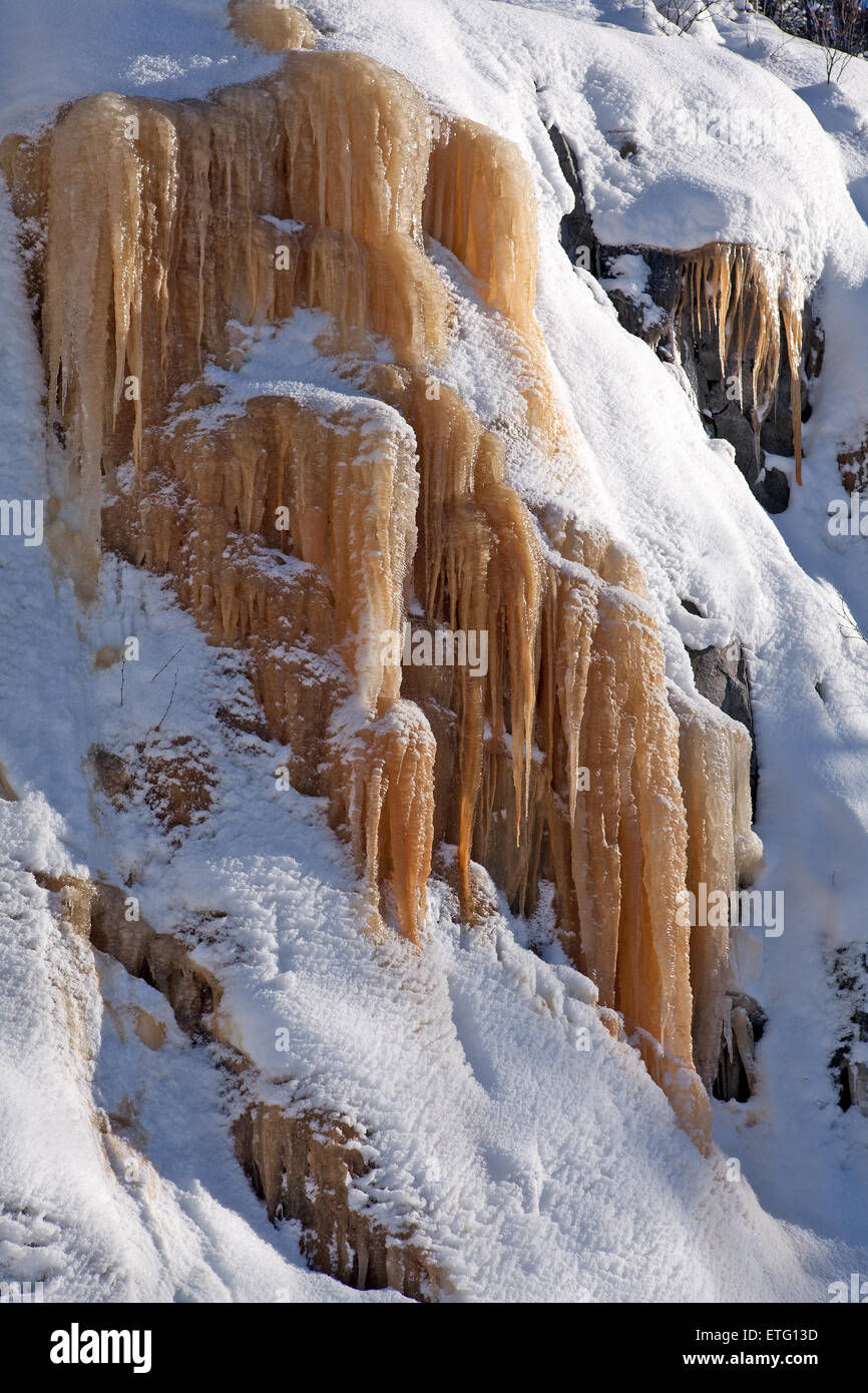 Iron oxide stained icicles on the side of a hill Stock Photo - Alamy