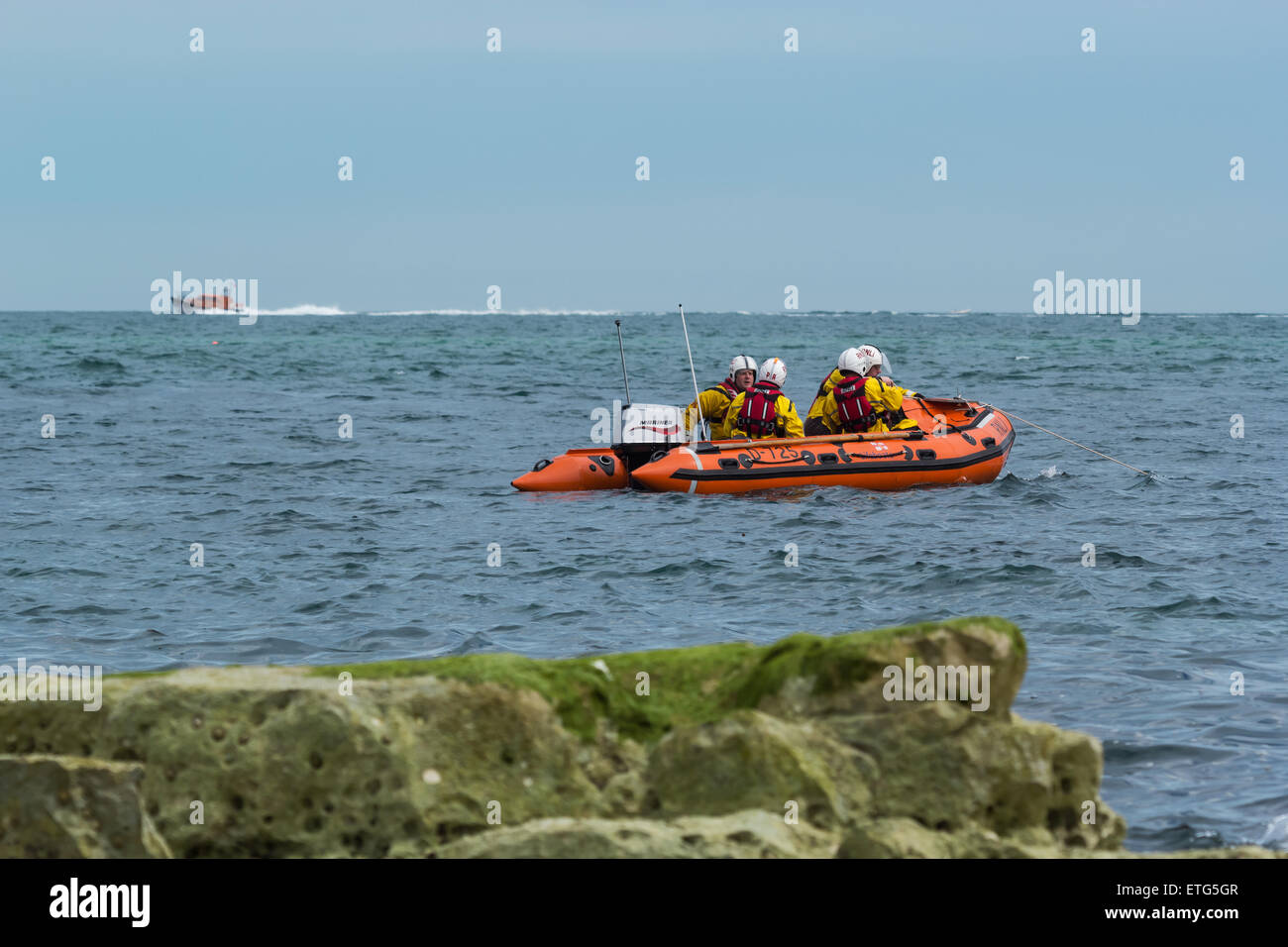 Lifeboat crew in their speedboat on sea during a search and rescue ...