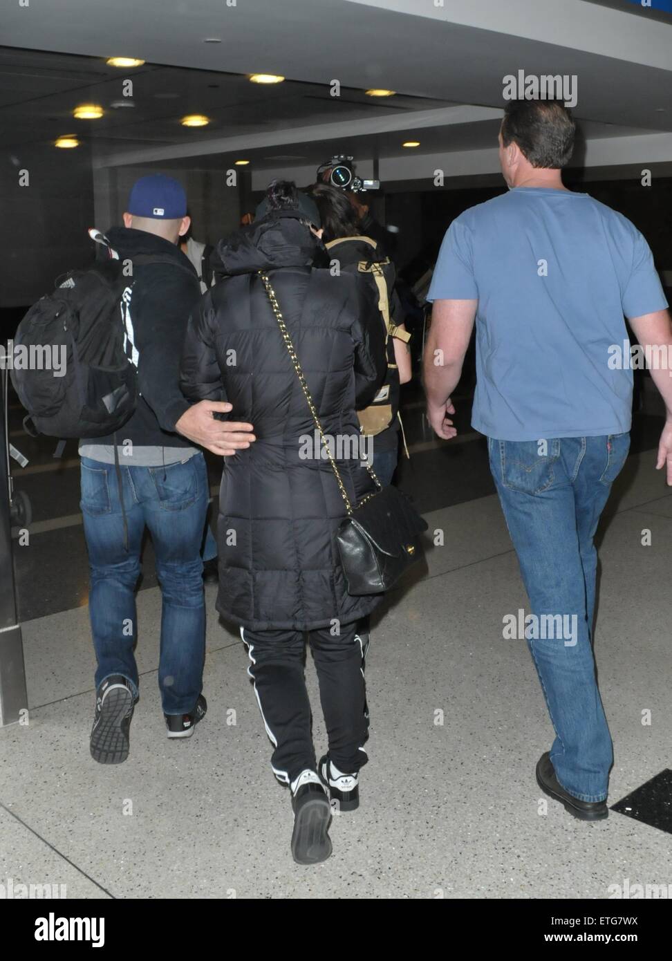 A camera-shy Katy Perry arrives at Los Angeles International Airport ...