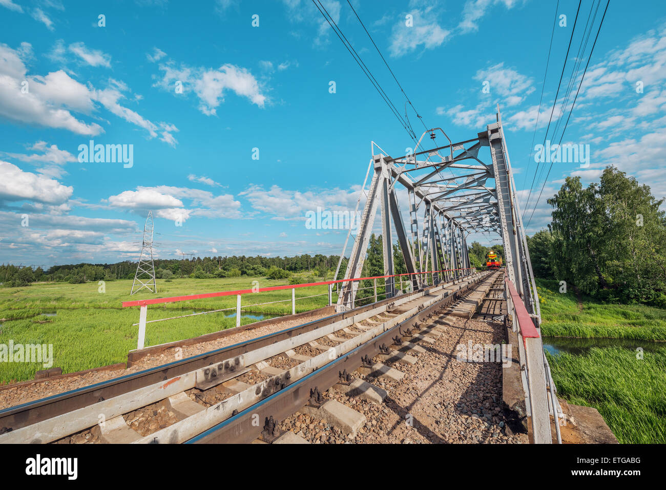 Freight train appoach to the railway bridge over the river Stock Photo ...