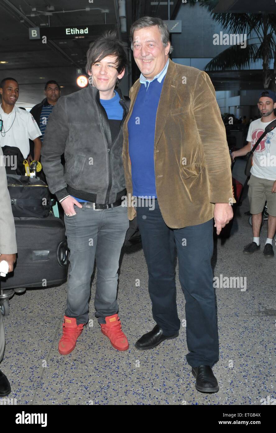 Stephen Fry and husband Elliot Spencer arrive at Los Angeles ...