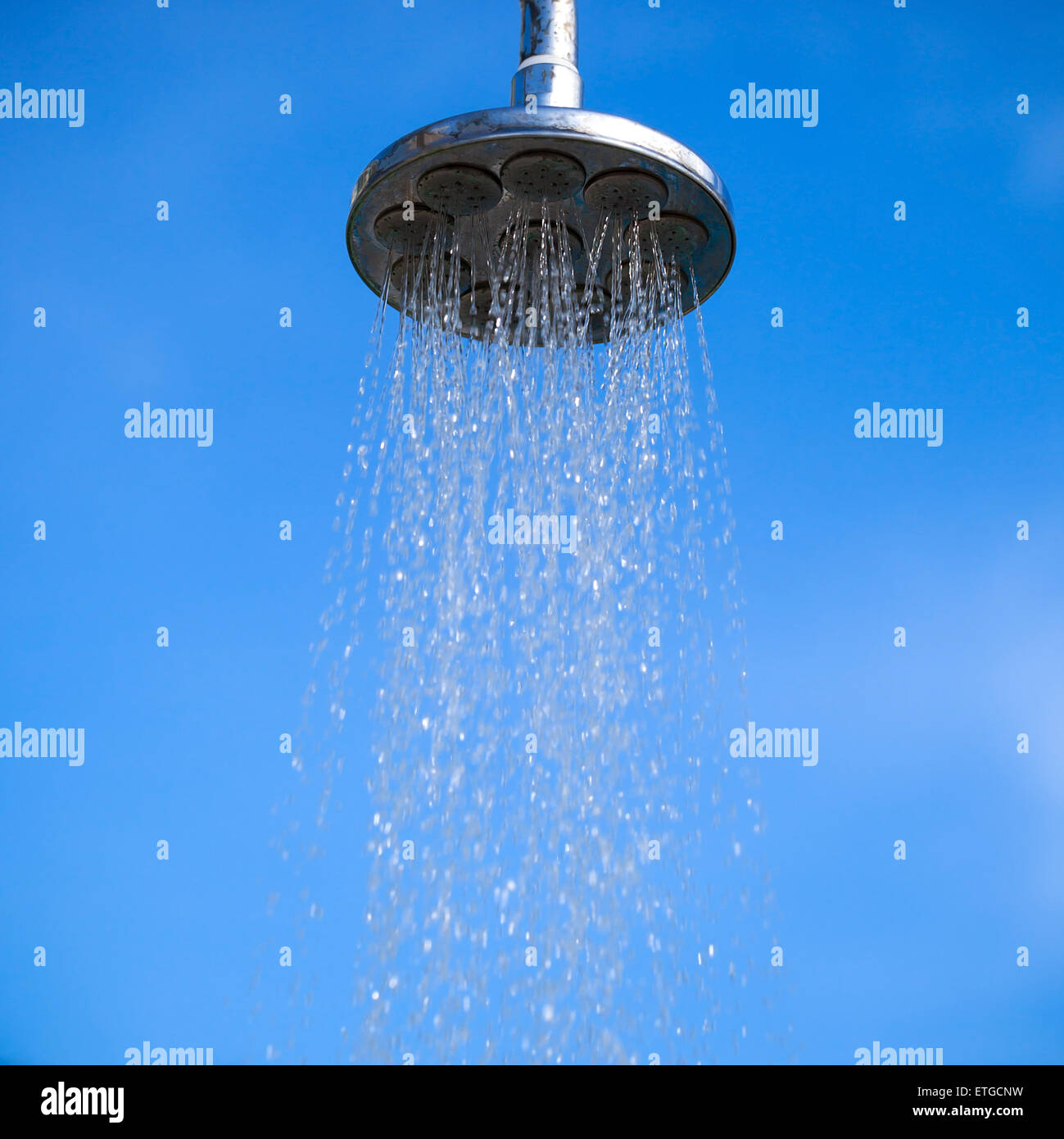 Water drops falling from a shower outside against blue sky Stock Photo ...