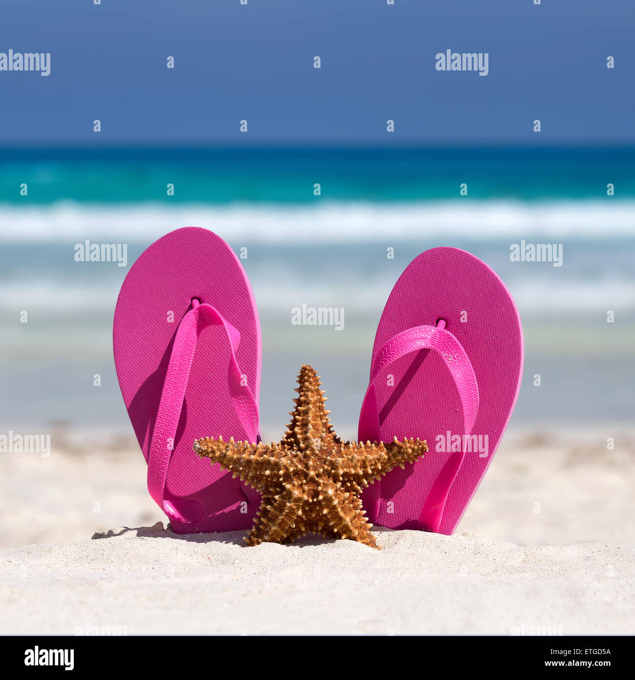 Pink flip flops and starfish on white sandy beach. Summer vacation ...