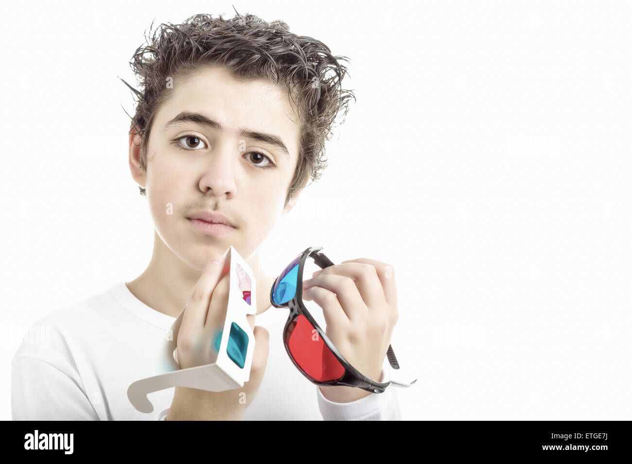 Caucasian boy with questioning eyes holds vintage white 3D Cinema ...