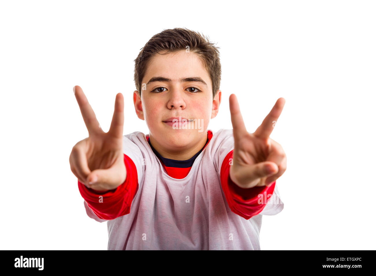 A handsome Caucasian boy makes double victory sign using both hands. He ...