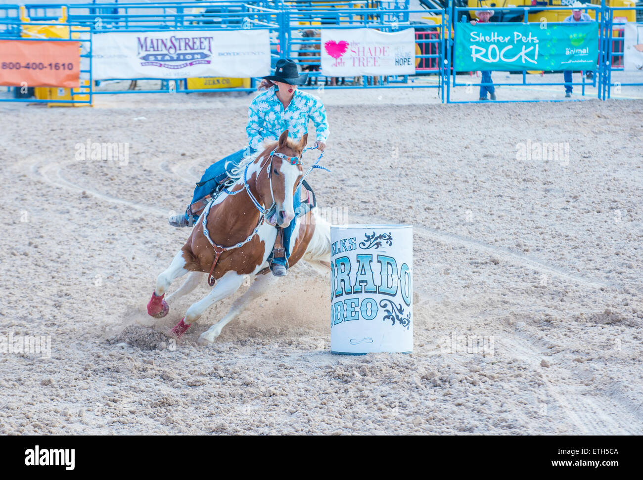Cowgirl Participating in a Barrel racing competition at the Helldorado ...