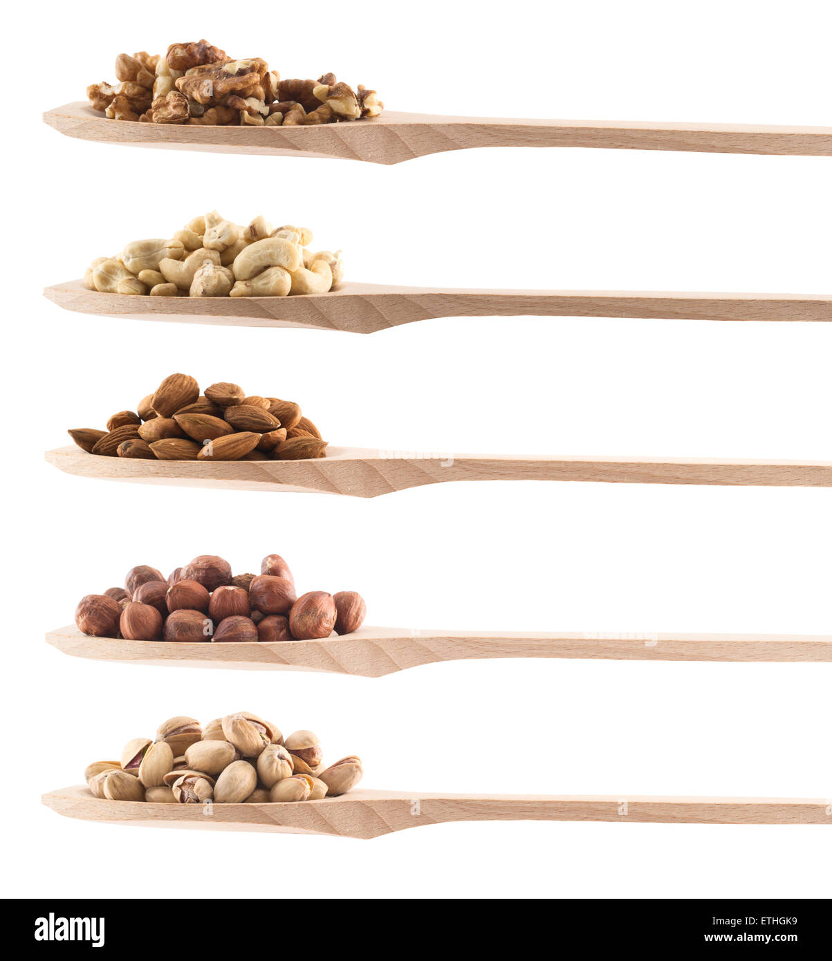 Wooden spoons full of different nuts Stock Photo - Alamy
