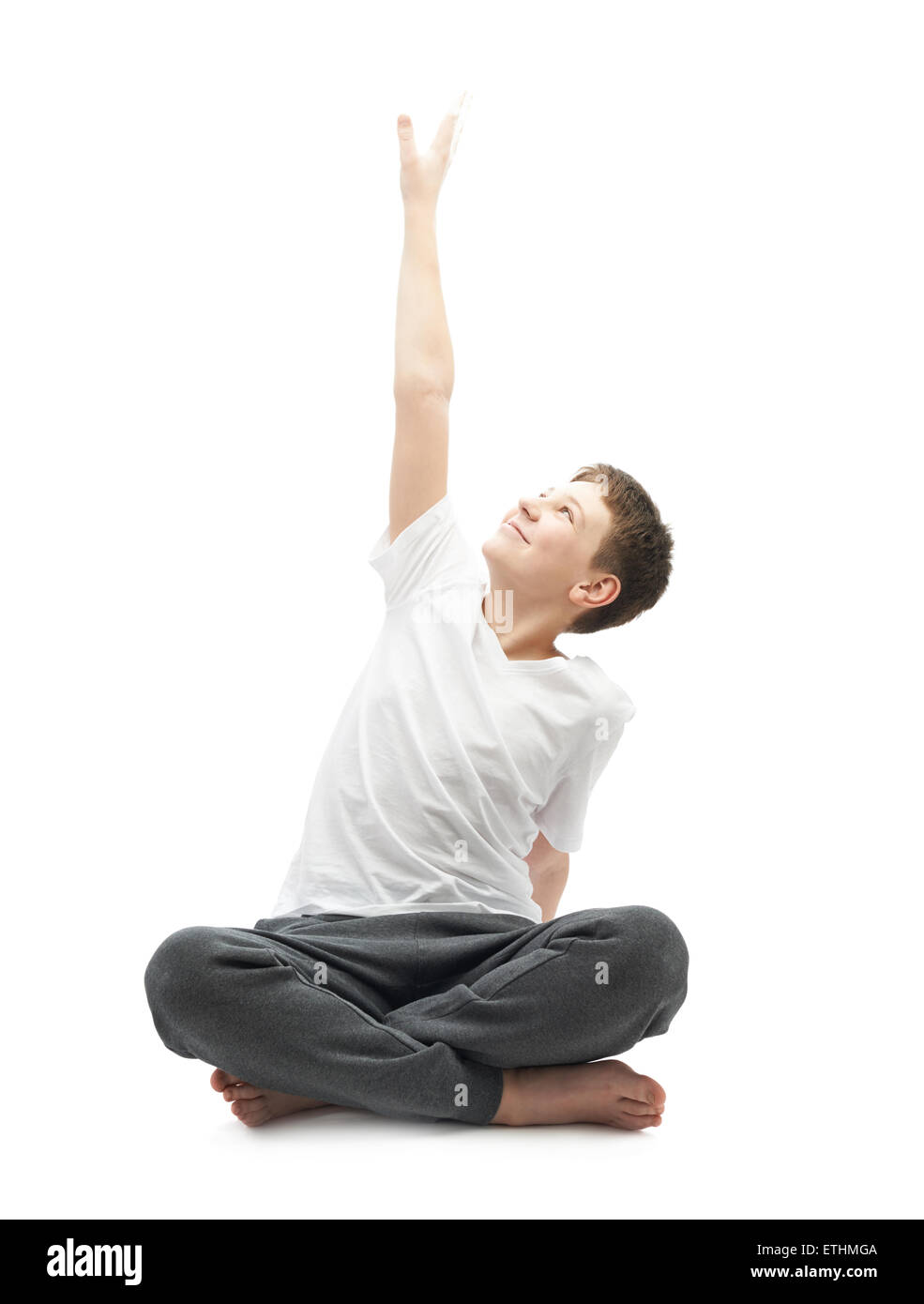Young boy stretching or doing yoga Stock Photo - Alamy