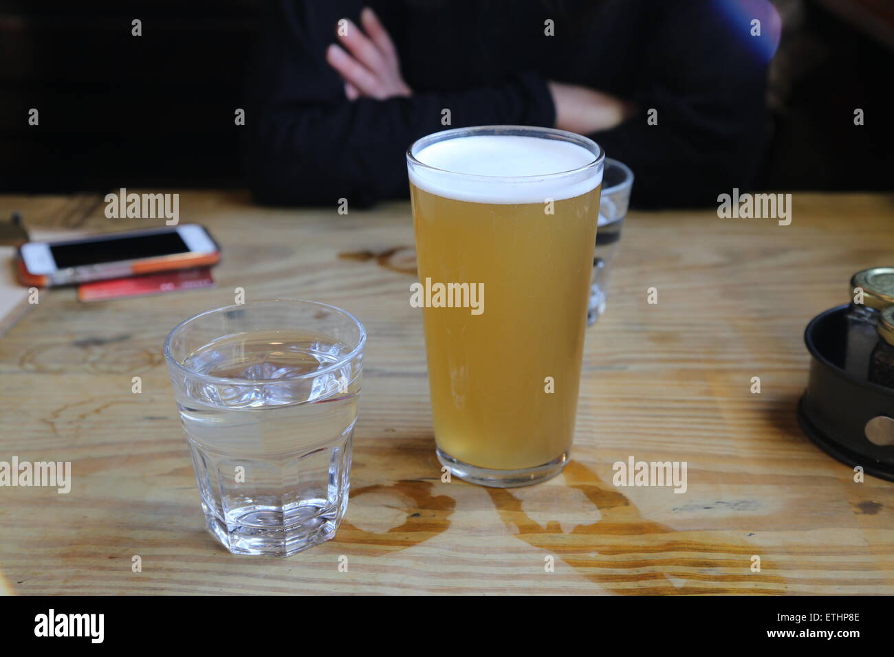 A pint of beer on a wooden table in Camden Stock Photo - Alamy