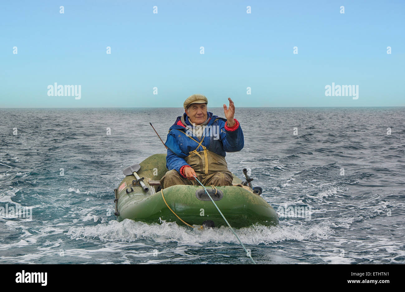 old fisherman inflatable boat russia nakhodka 20.04.2014 Stock Photo ...