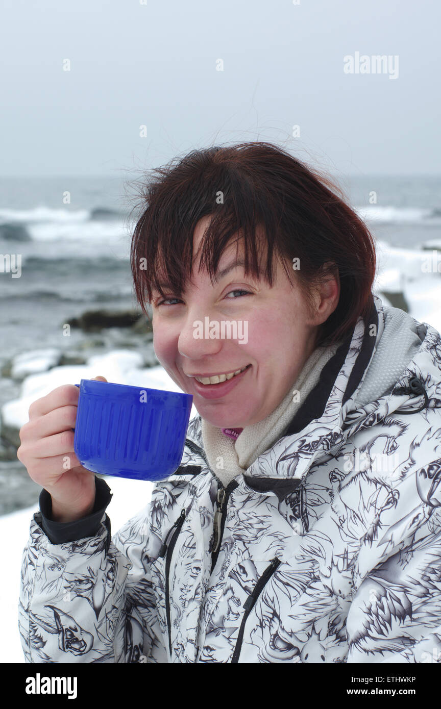 Woman drinking coffee on cold hi-res stock photography and images - Alamy