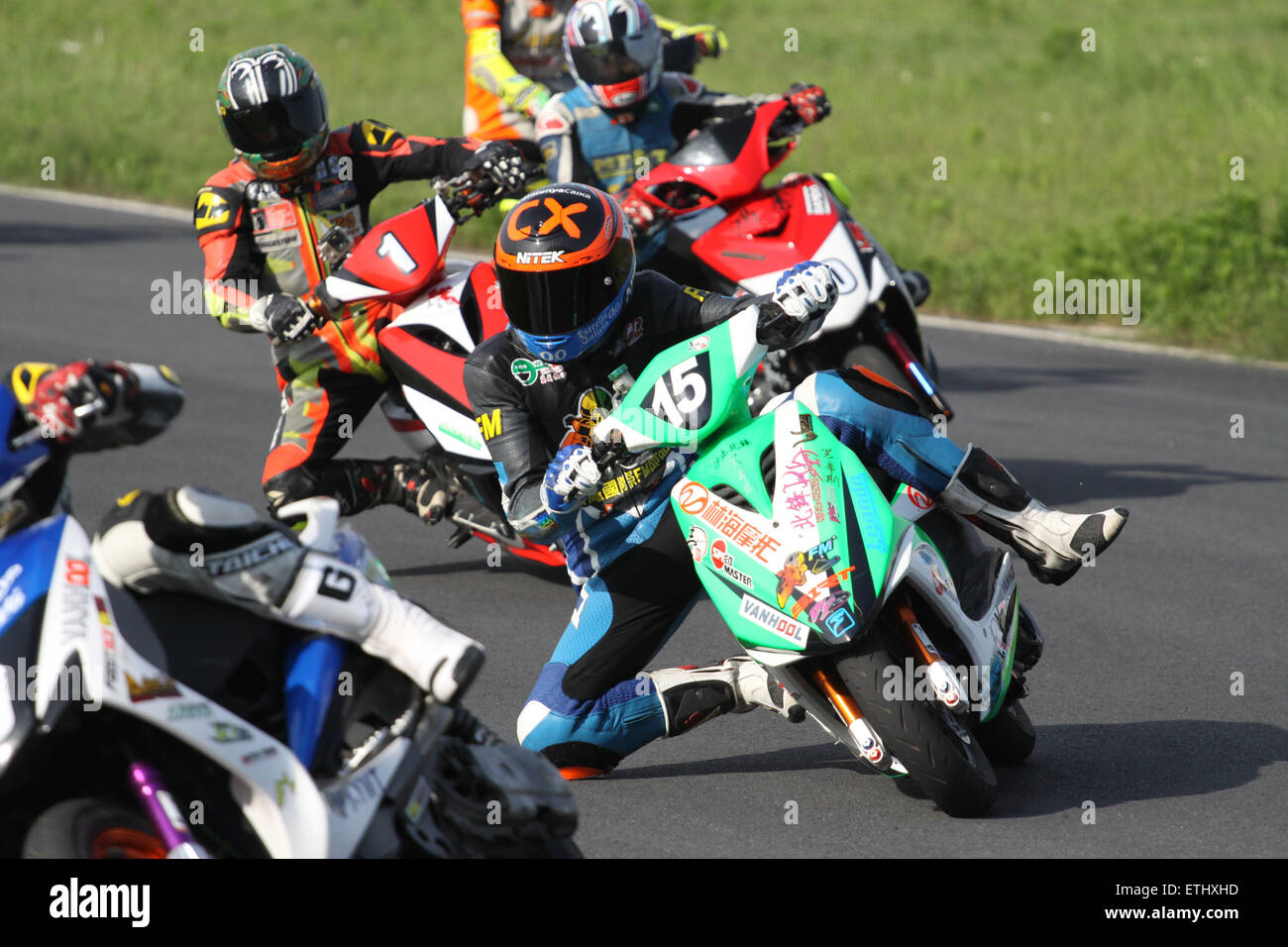 Xiangyang, China. 14th June, 2015. An athlete rides a motorbike in a ...