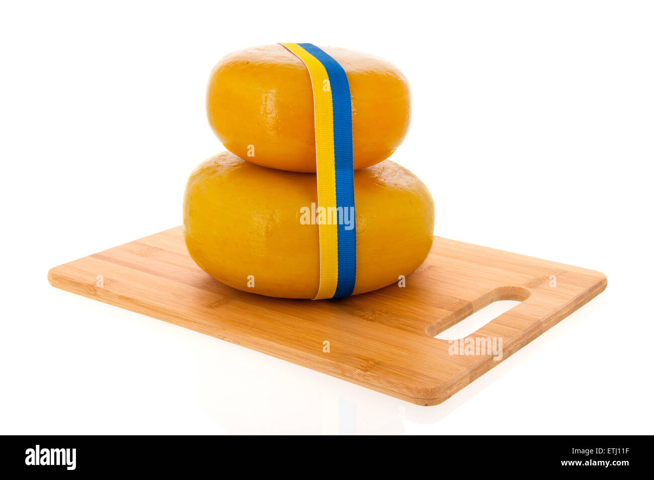 two whole Swedish cheeses on wooden cutting board Stock Photo - Alamy