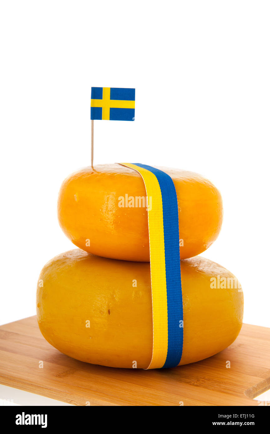 two whole Swedish cheeses on wooden cutting board Stock Photo - Alamy