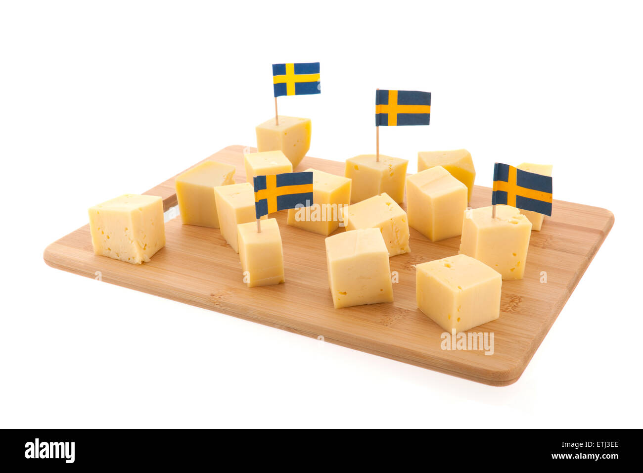 Cubes Swedish cheese on wooden cutting board Stock Photo - Alamy